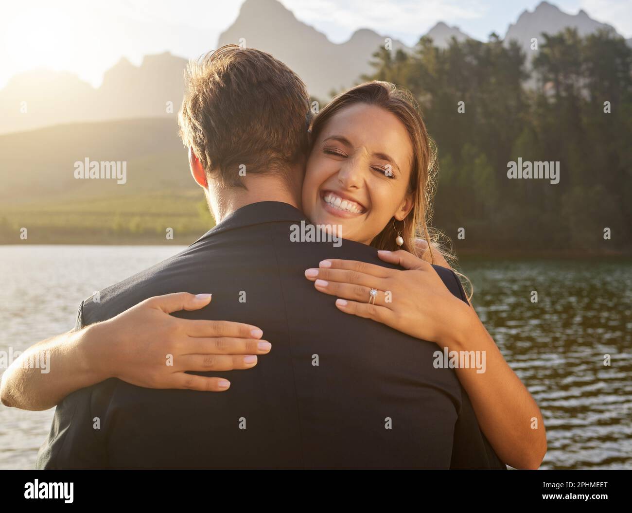 Wedding, lake and happy couple hugging in nature and water with passion ...