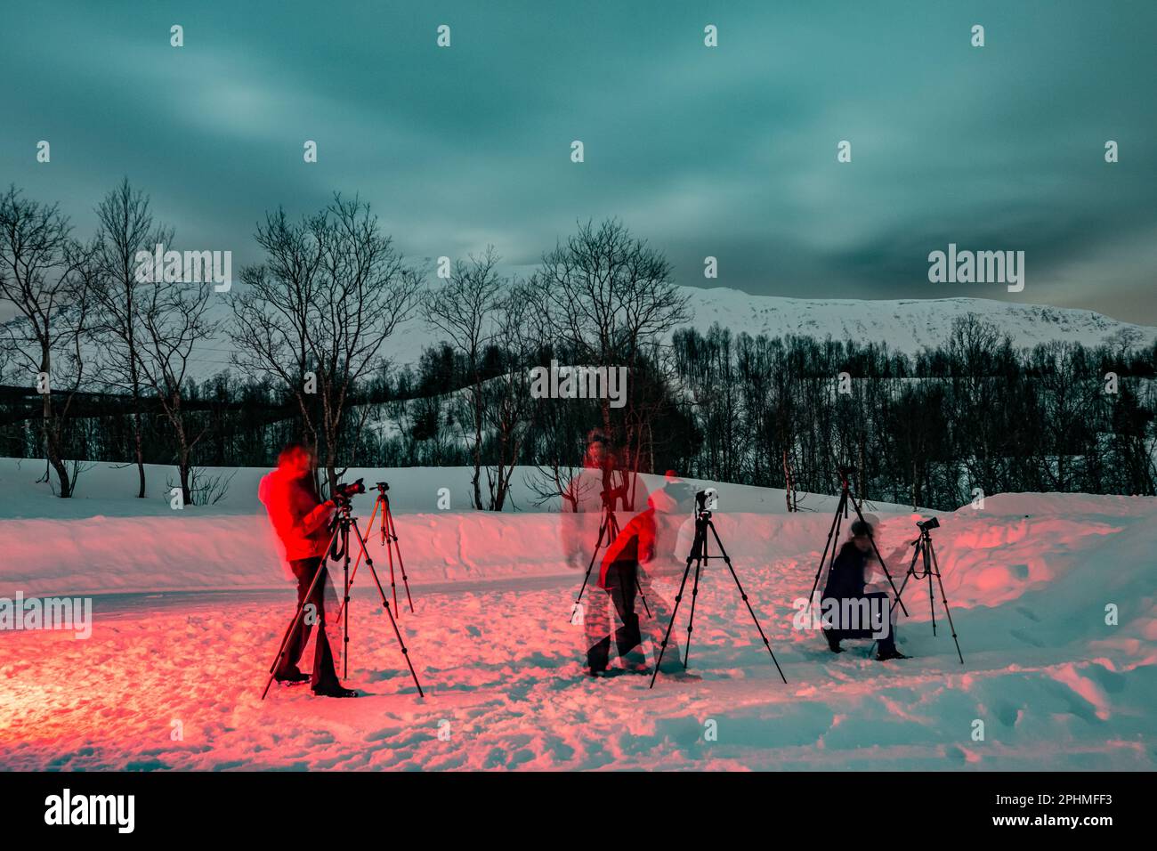 Long exposure, 30 seconds, three photographers at night in the polar ...