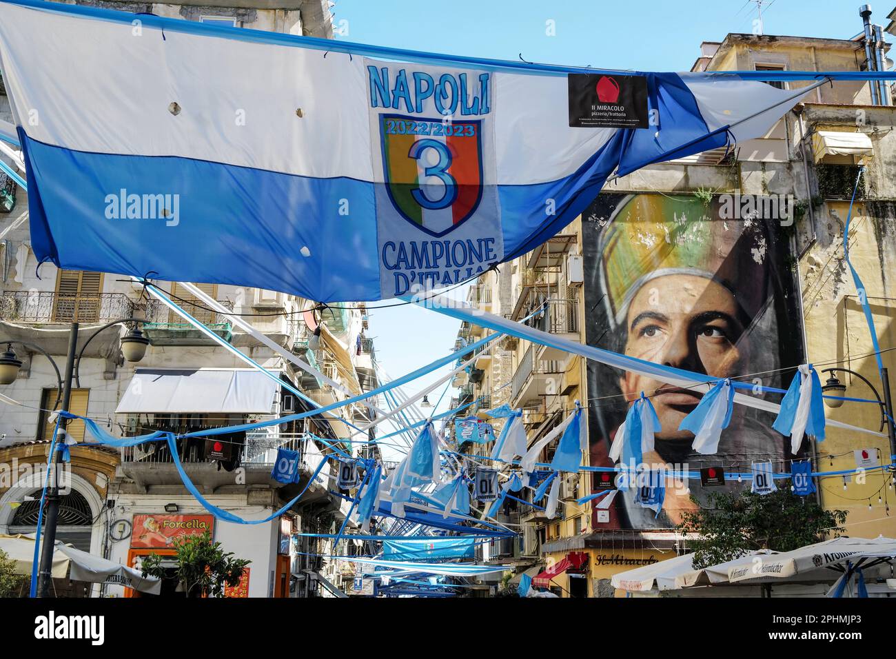 Banners, flags and a mural of San Gennaro by the artist Jorit, are seen ...