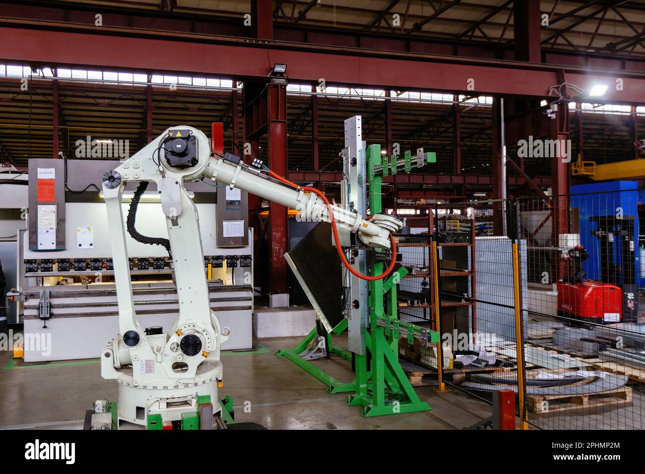 Robotic arm working with metal sheet at metalworking factory Stock ...