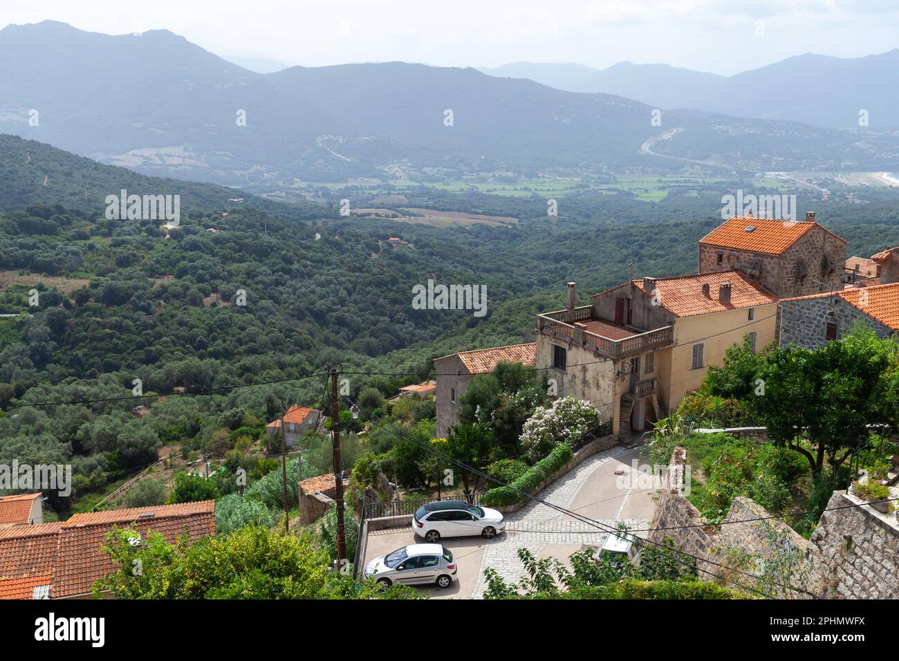 Olmeto town street view with old stone houses on a summer day, Corsica ...