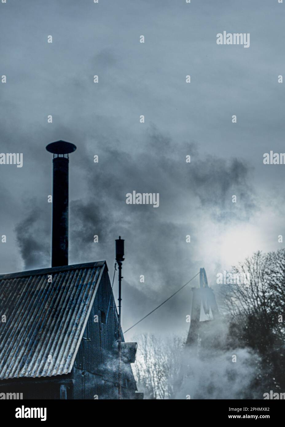 Steam and smoke eminating from engine shed at a mine head Stock Photo ...