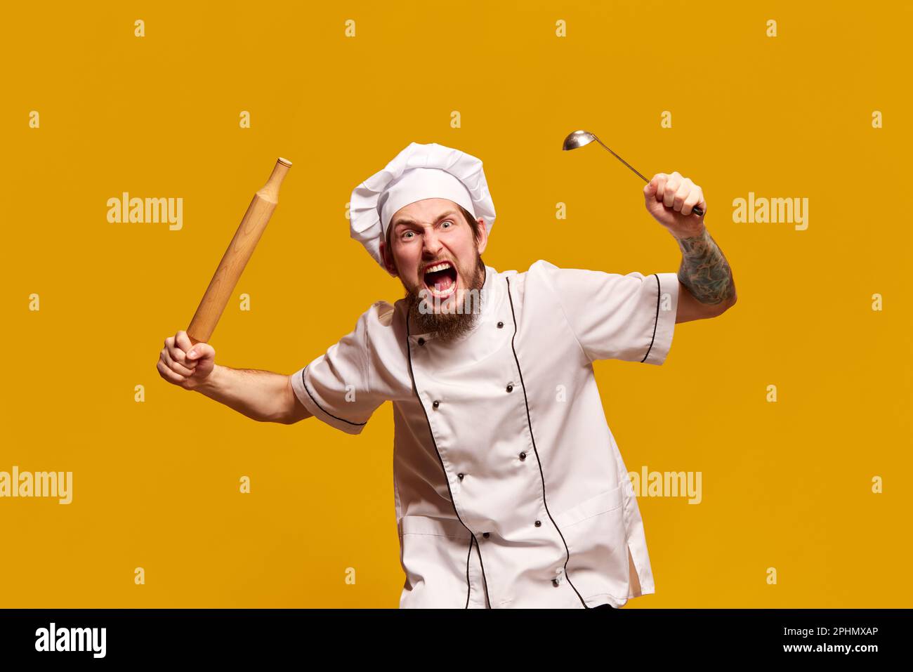 Portrait of emotional young man in white uniform of chef with cooking ...