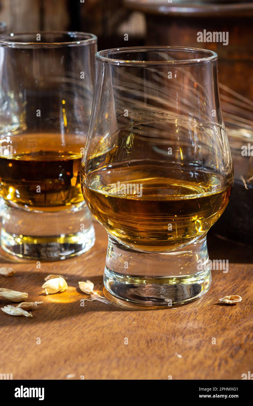 Small tasting glasses with aged Scotch whisky on old dark wooden ...