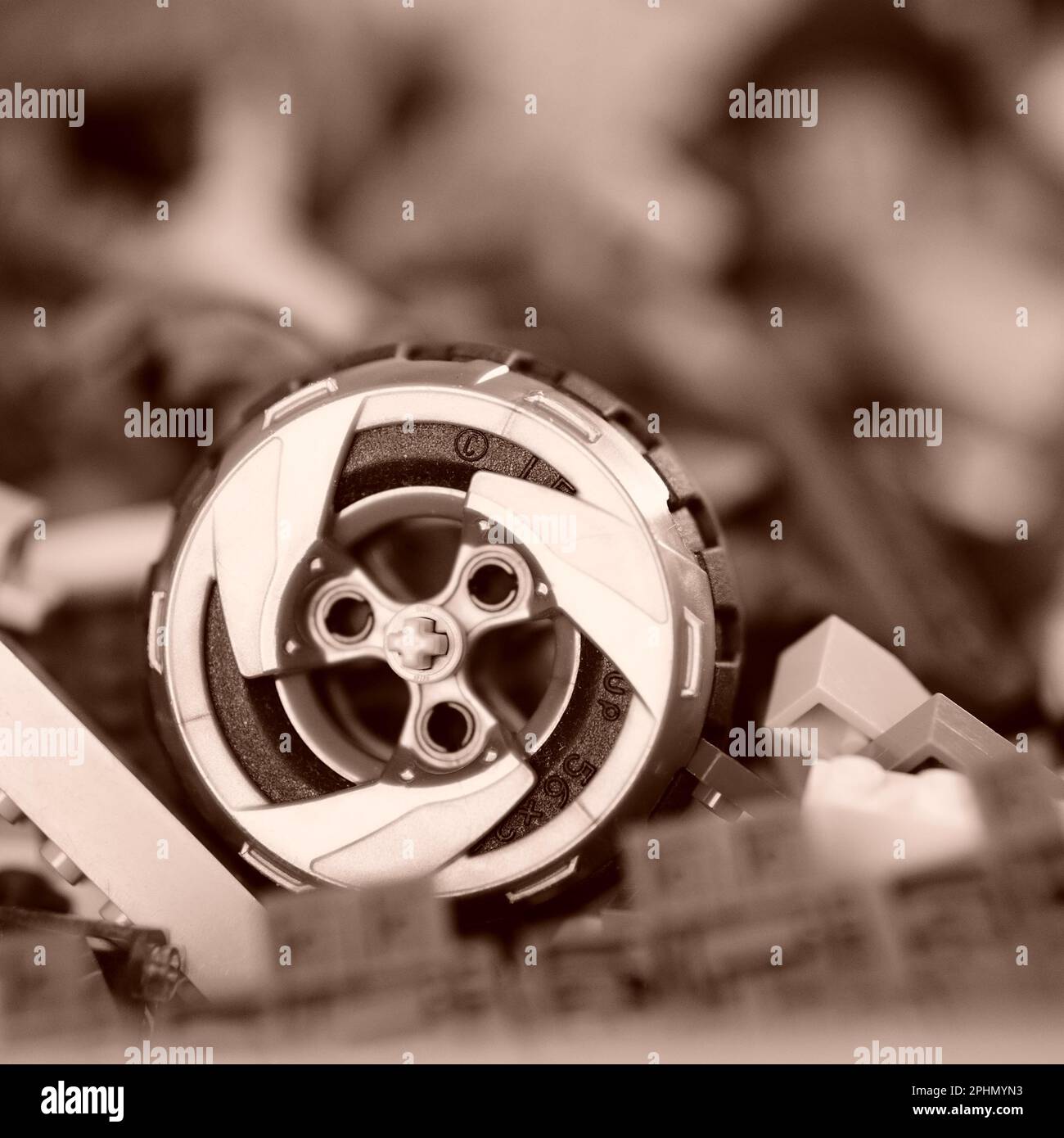 A plastic Lego wheel atop of bricks Stock Photo - Alamy