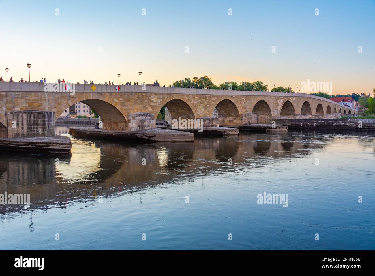 Old stone bridge over river Danube in Regensburg, Germany Stock Photo ...