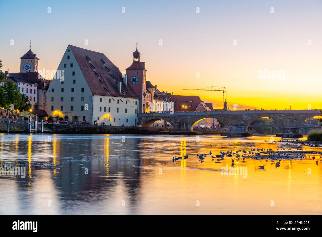 Sunset view of the Old stone bridge over river Danube in Regensburg ...