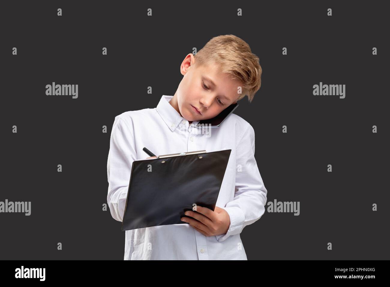 kids business confident boy phone call writing Stock Photo - Alamy