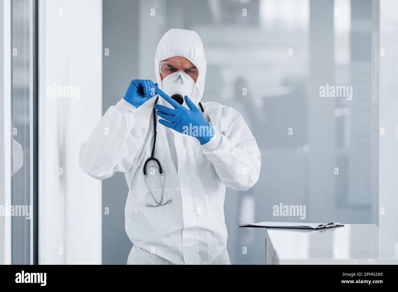 Person taking off blue medical hi-res stock photography and images - Alamy