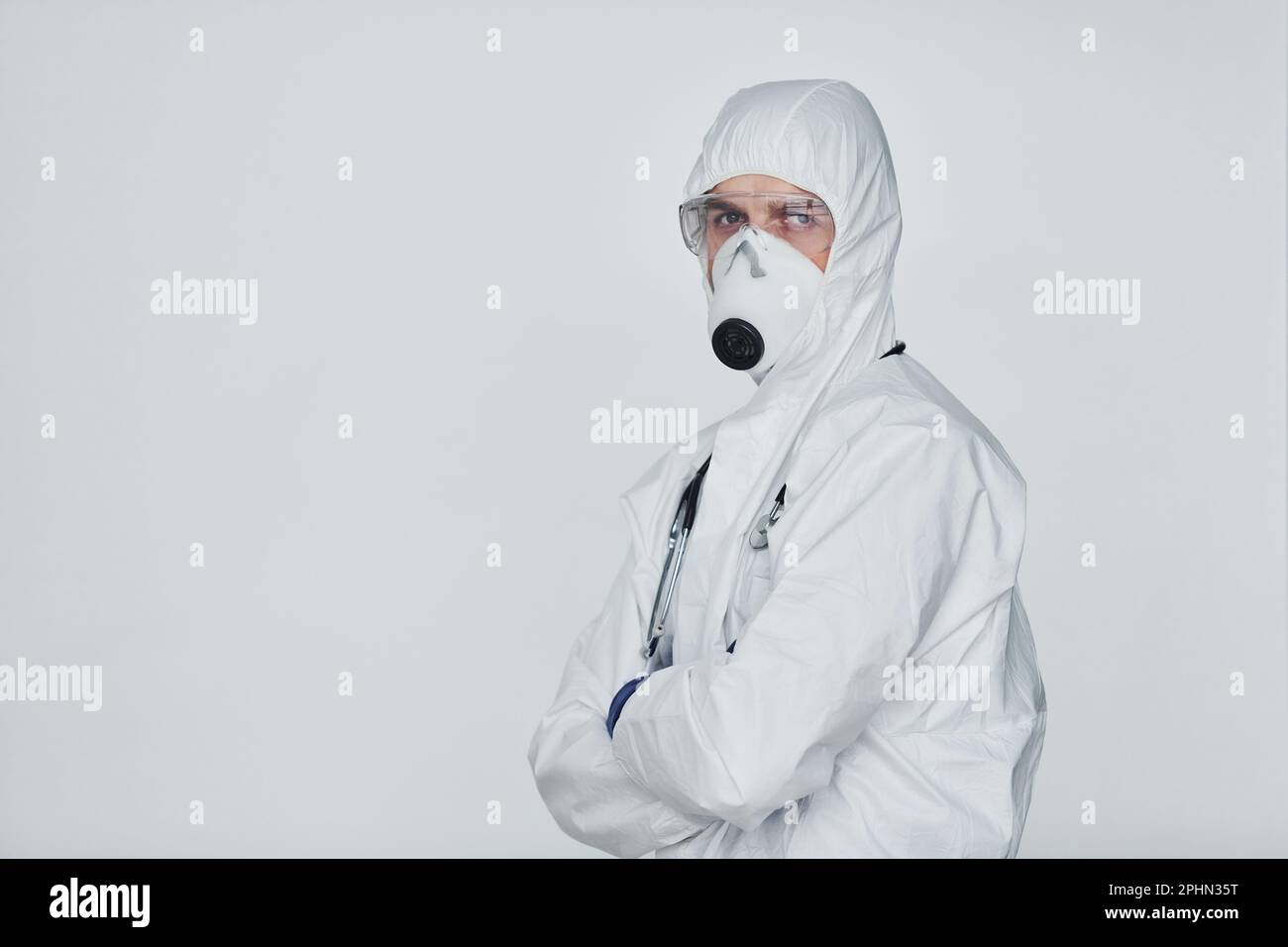 Male doctor scientist in lab coat, defensive eyewear and mask standing ...