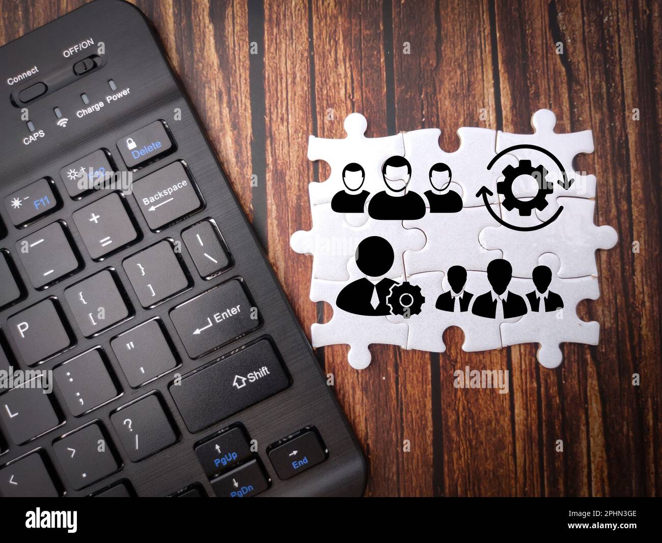 Wireless keyboard and puzzle with teamwork and team management icons ...