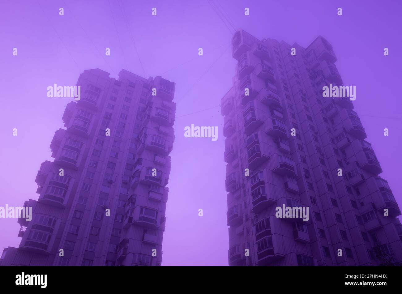 Tall residential buildings in the form of a tower, immersed in a misty ...