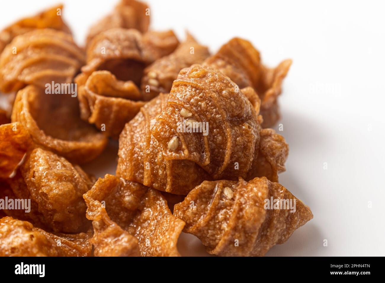Conch shaped snacks on a white background Stock Photo - Alamy