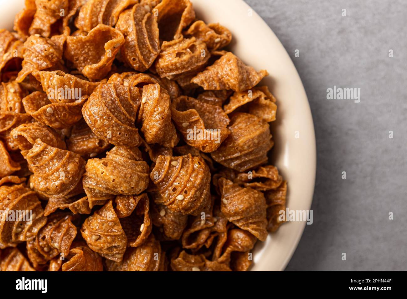 Sweet and crunchy conch-shaped snacks Stock Photo - Alamy
