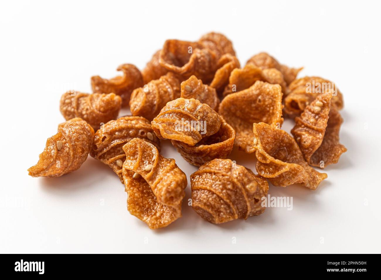 Conch shaped snacks on a white background Stock Photo - Alamy