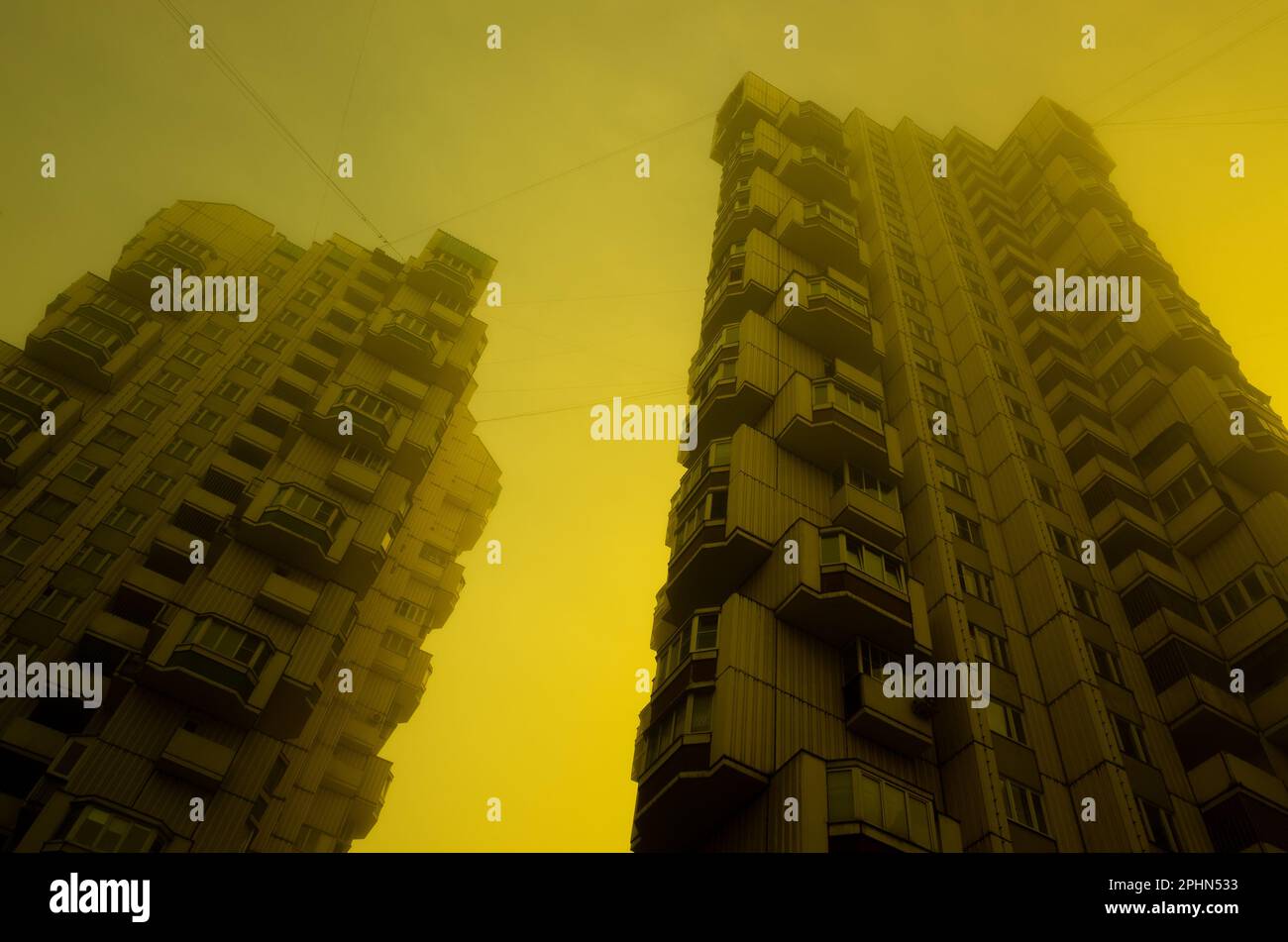 Tall residential buildings in the form of a tower, immersed in a misty ...