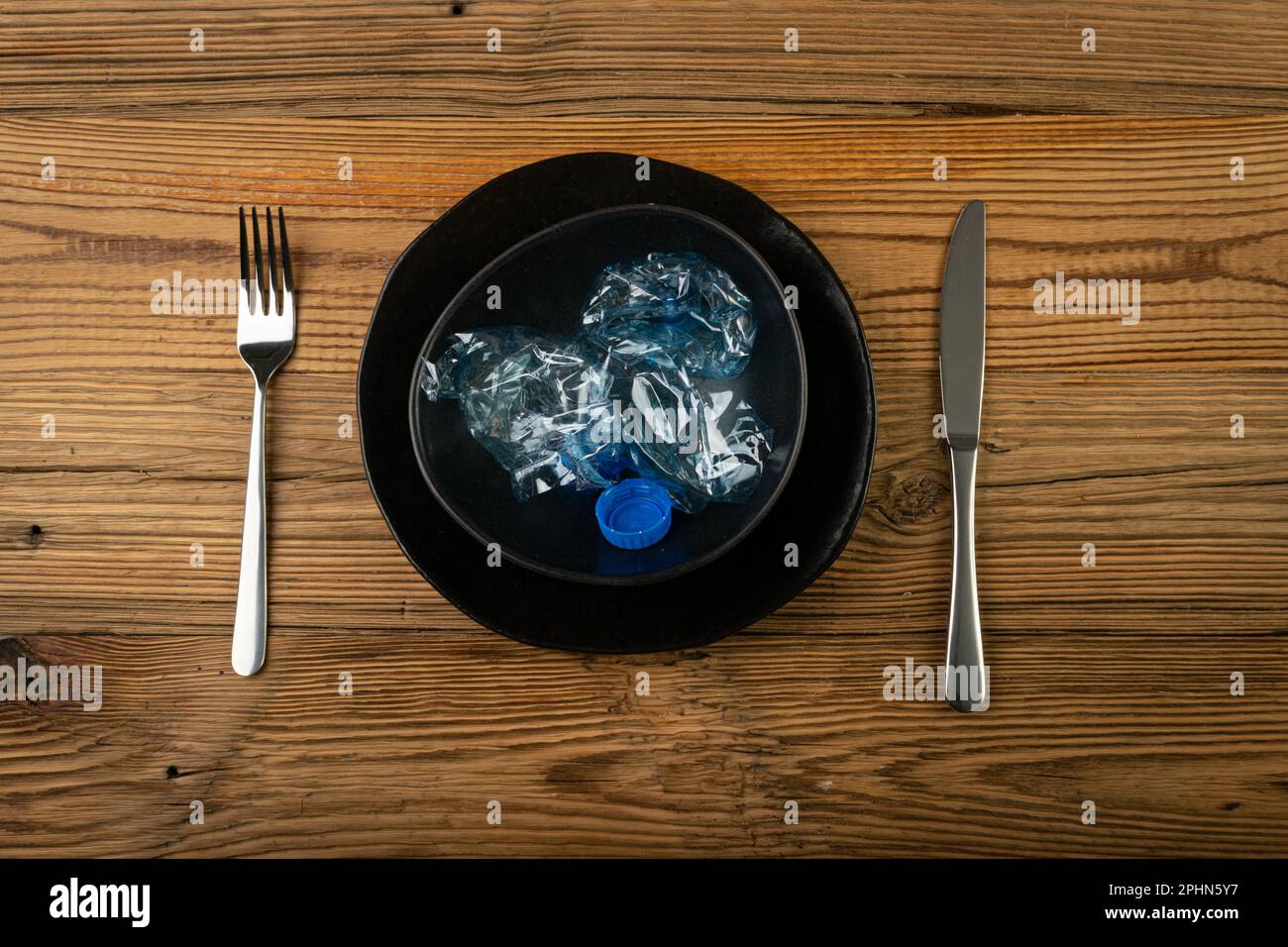 Eat Plastic, Blue Empty Plastic Bottle on Plate, Crumpled Plastic ...