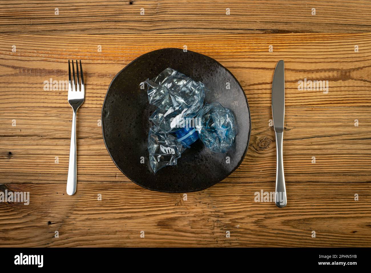 Eat Plastic, Blue Empty Plastic Bottle on Plate, Crumpled Plastic ...