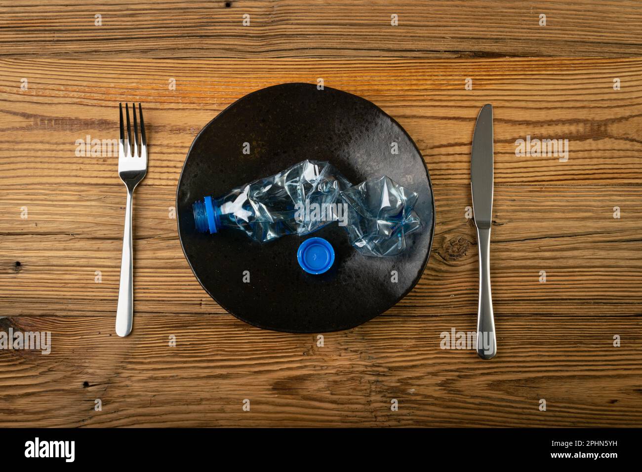 Eat Plastic, Blue Empty Plastic Bottle on Plate, Crumpled Plastic ...