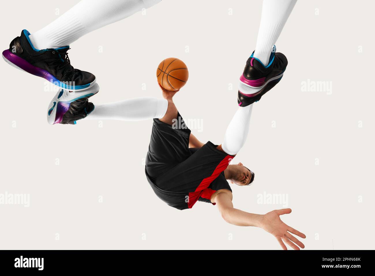 Portrait of basketball player training with ball over white background ...
