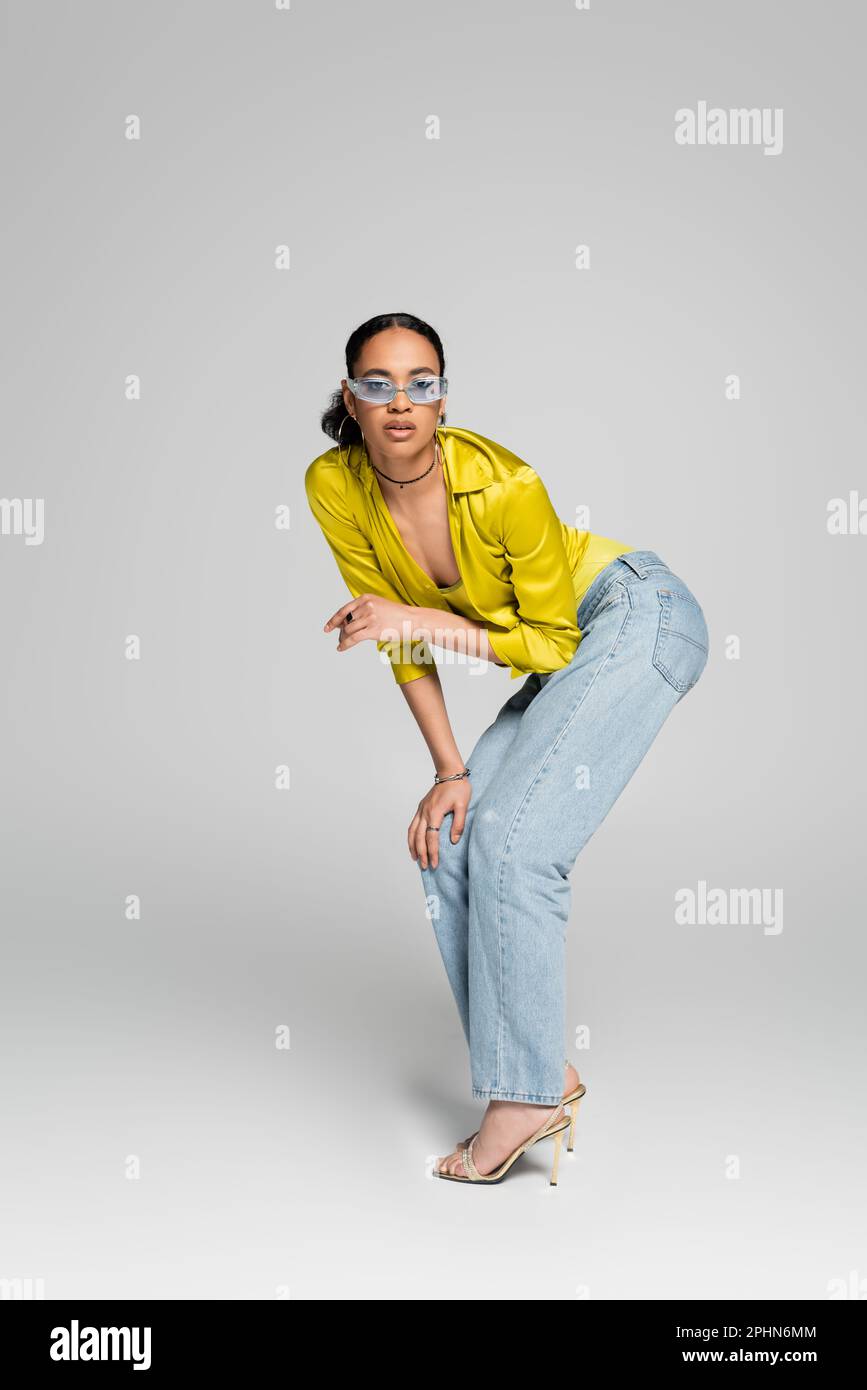 full length of stylish african american woman in trendy outfit and high ...