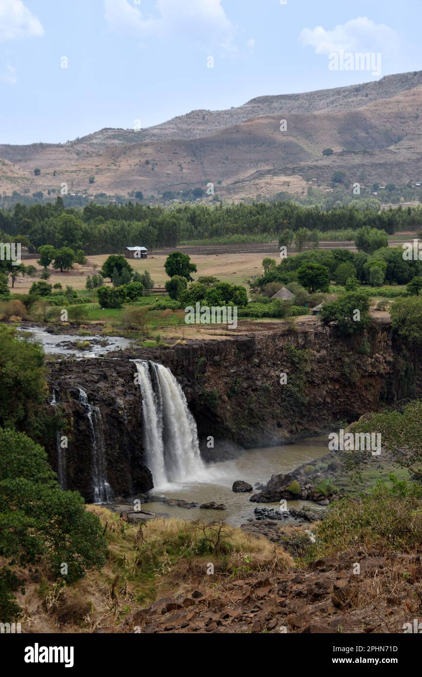 A scenic view of a majestic waterfall cascading down from cliffs. Nile River, Ethiopia, East ...