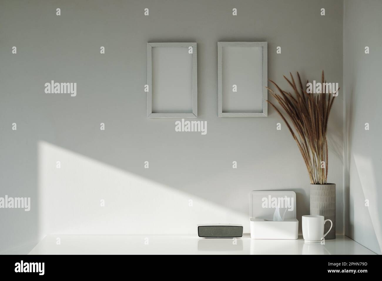 Empty picture frames above console Stock Photo - Alamy