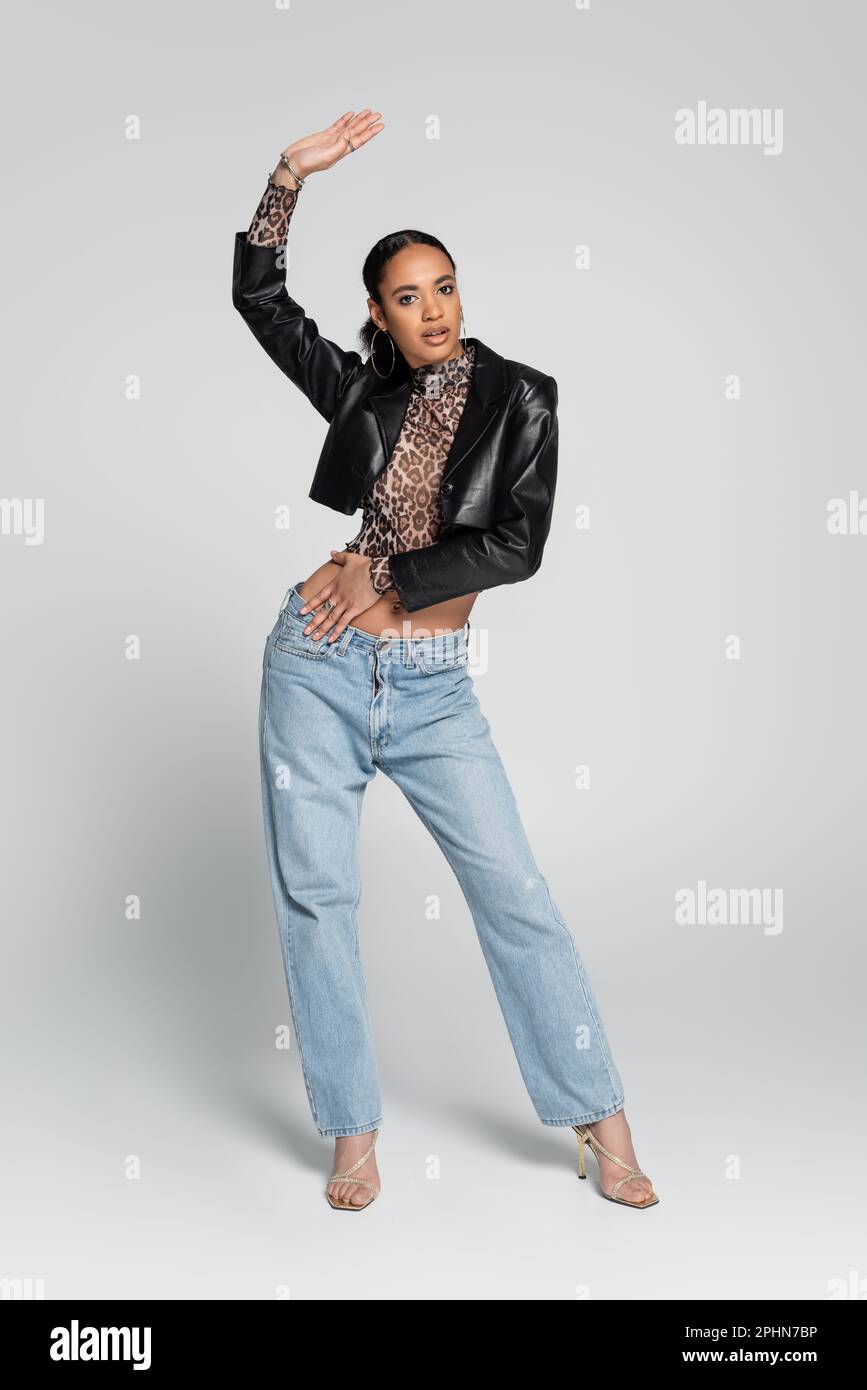 full length of fashionable african american woman in black cropped ...