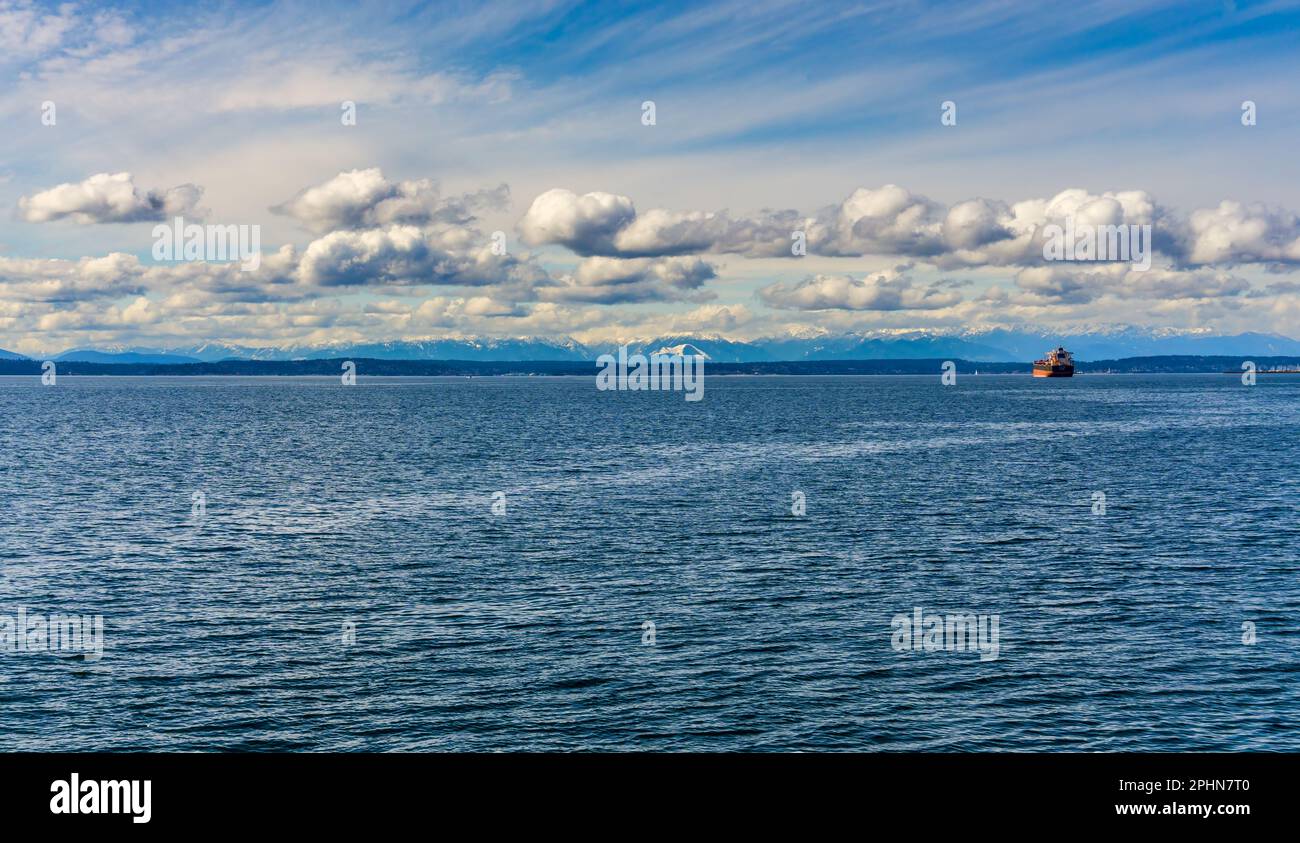 A tanker ship in Elliott Bay with the Olympic Mouintain range in the ...