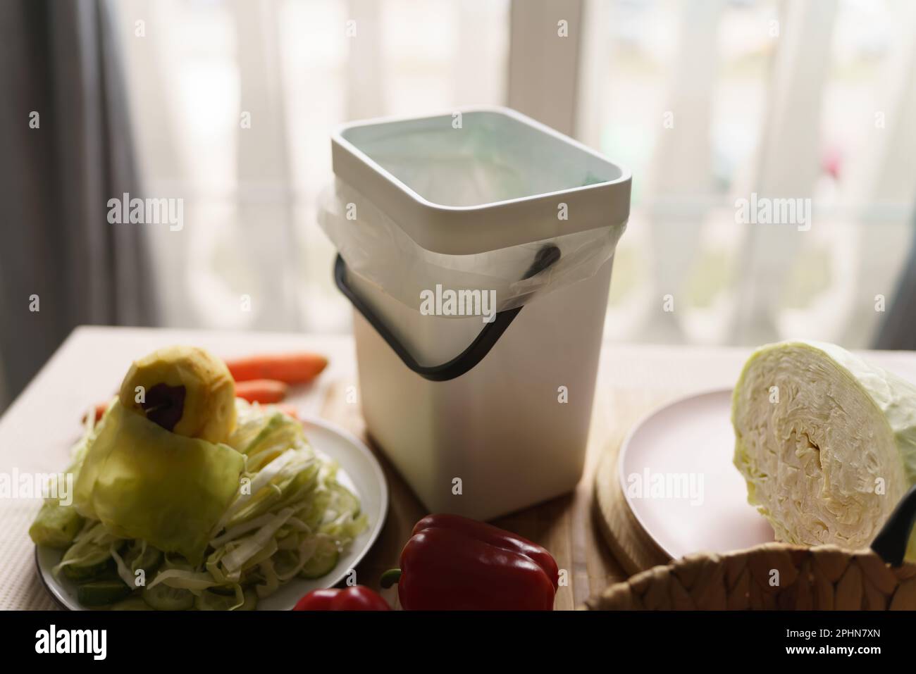 Compost bin on a kitchen table. Recycle organic food waste in a bokashi ...