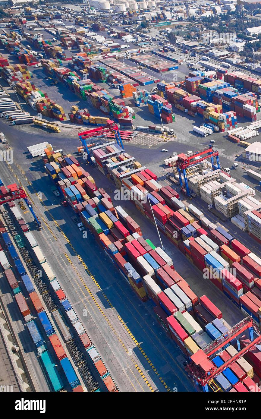 Stacked cargo containers aerial view. Containers at logistics terminal. Cargo container outdoor ...