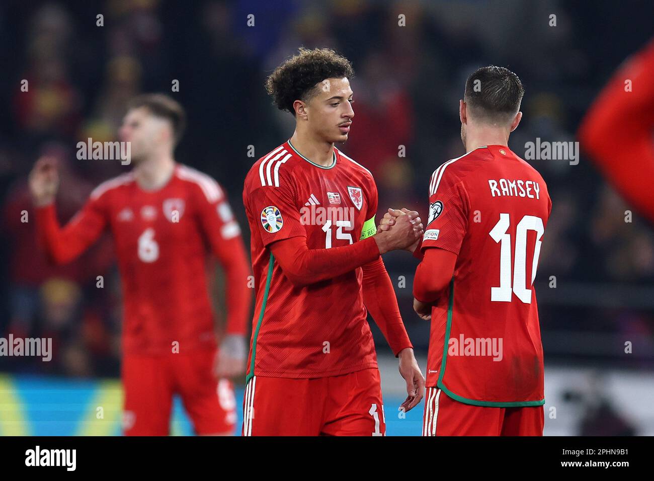 Cardiff, UK. 28th Mar, 2023. Aaron Ramsey of Wales (r) hands the ...