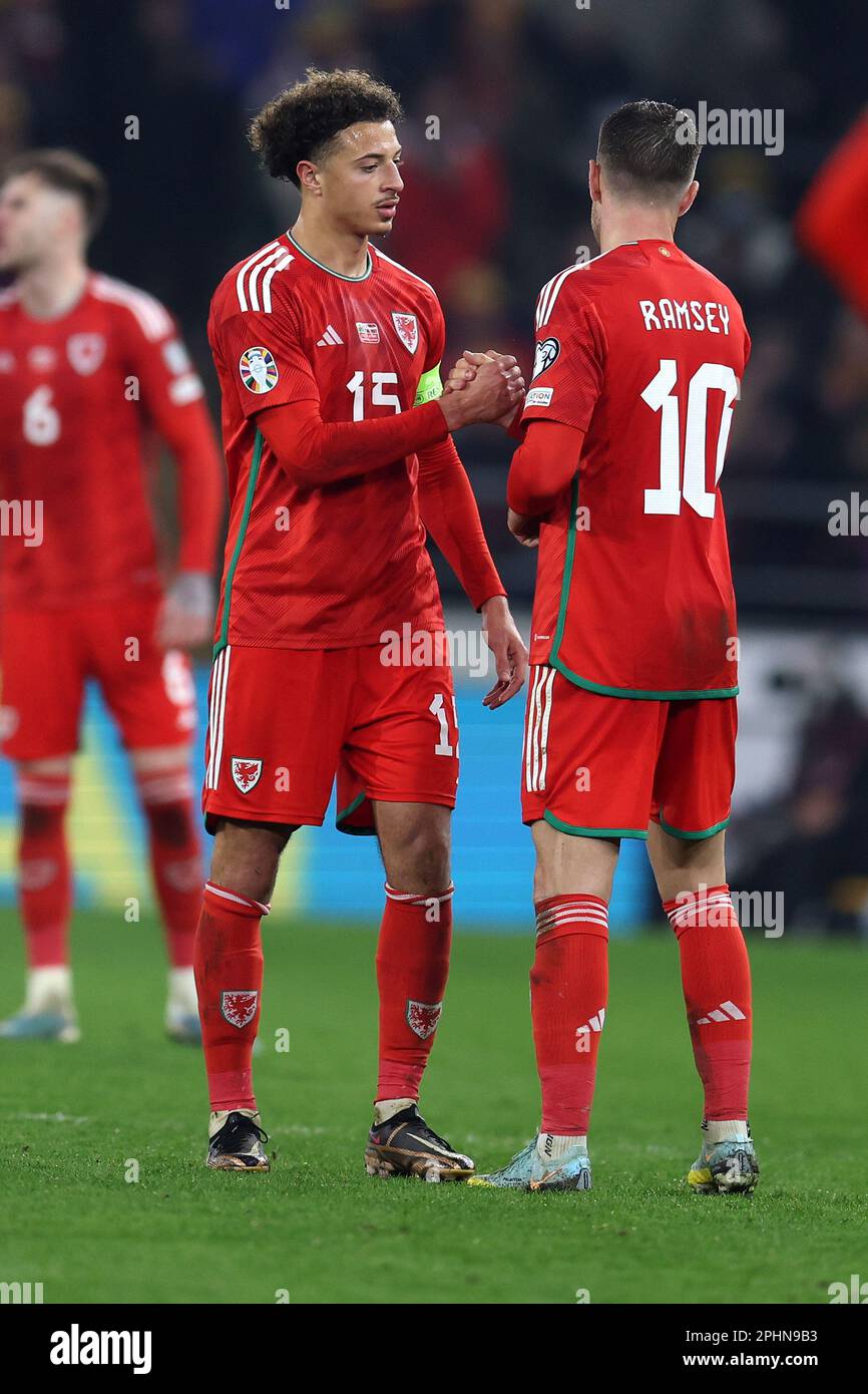 Cardiff, UK. 28th Mar, 2023. Aaron Ramsey of Wales (r) hands the ...