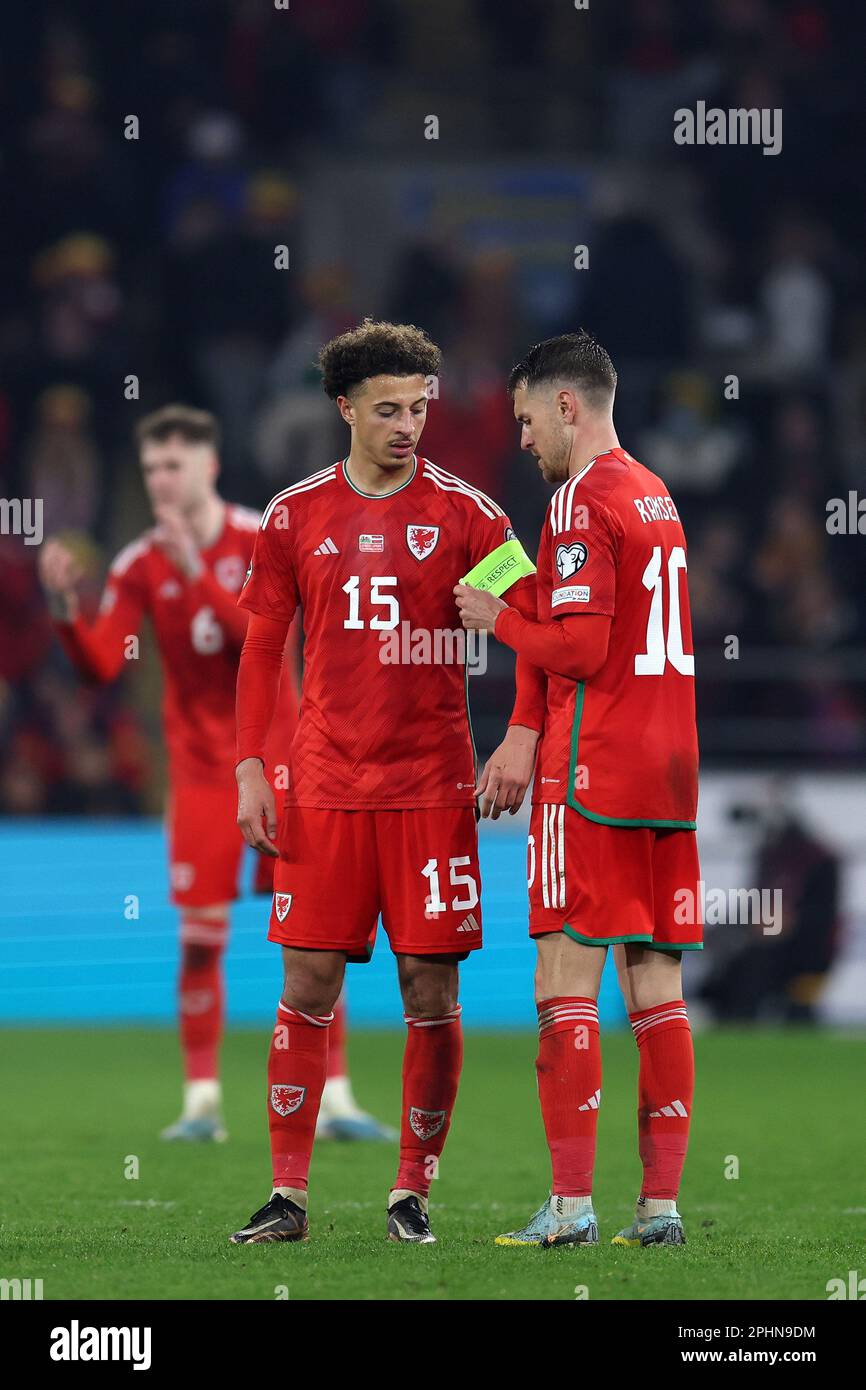 Cardiff, UK. 28th Mar, 2023. Aaron Ramsey of Wales (r) hands the ...