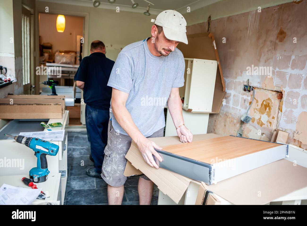 Kitchen Fitters: Making Drawers. A carpenter constructing flatpack ...