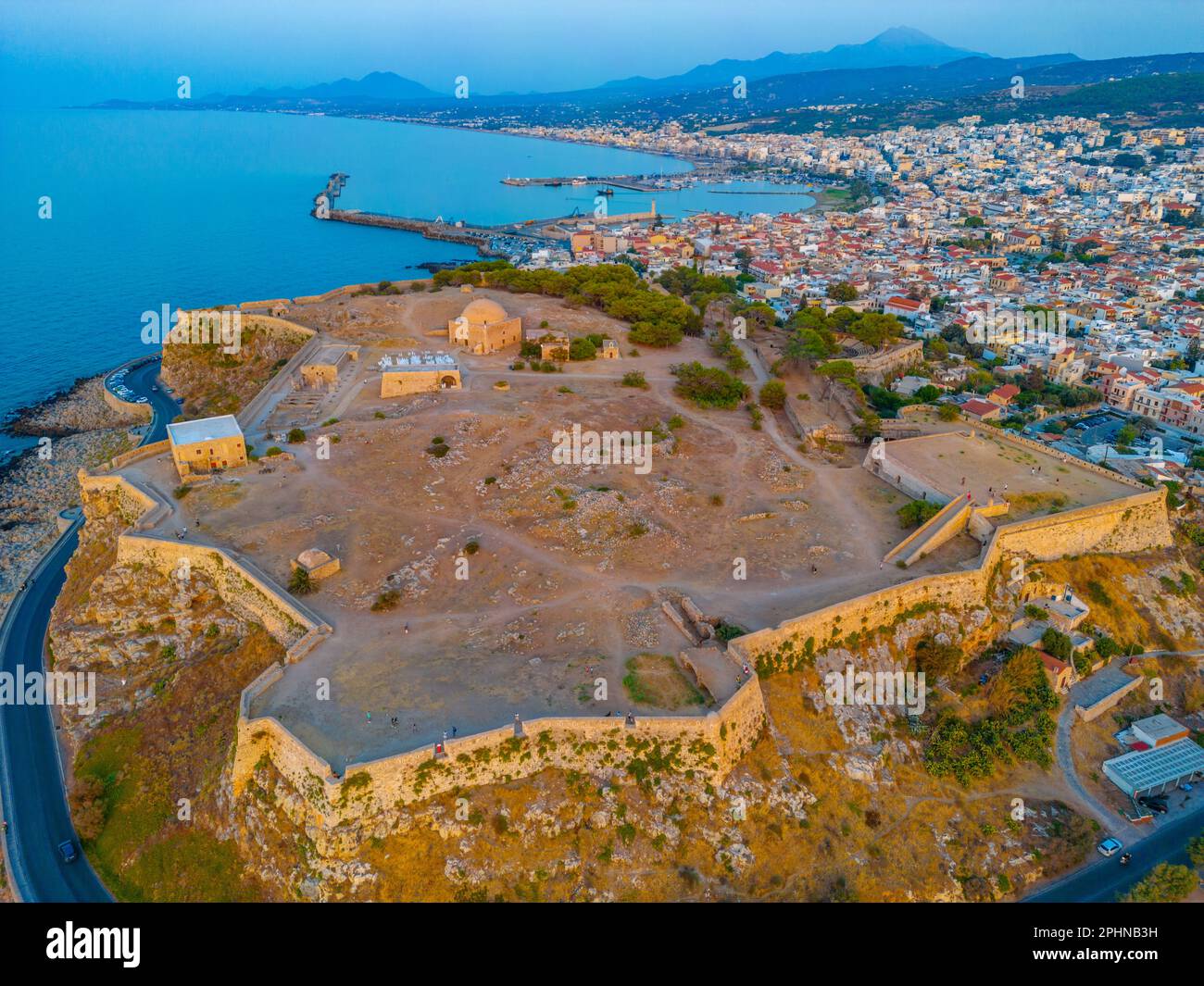Sunset aerial view of Venetian Fortezza Castle in Greek town Rethimno ...