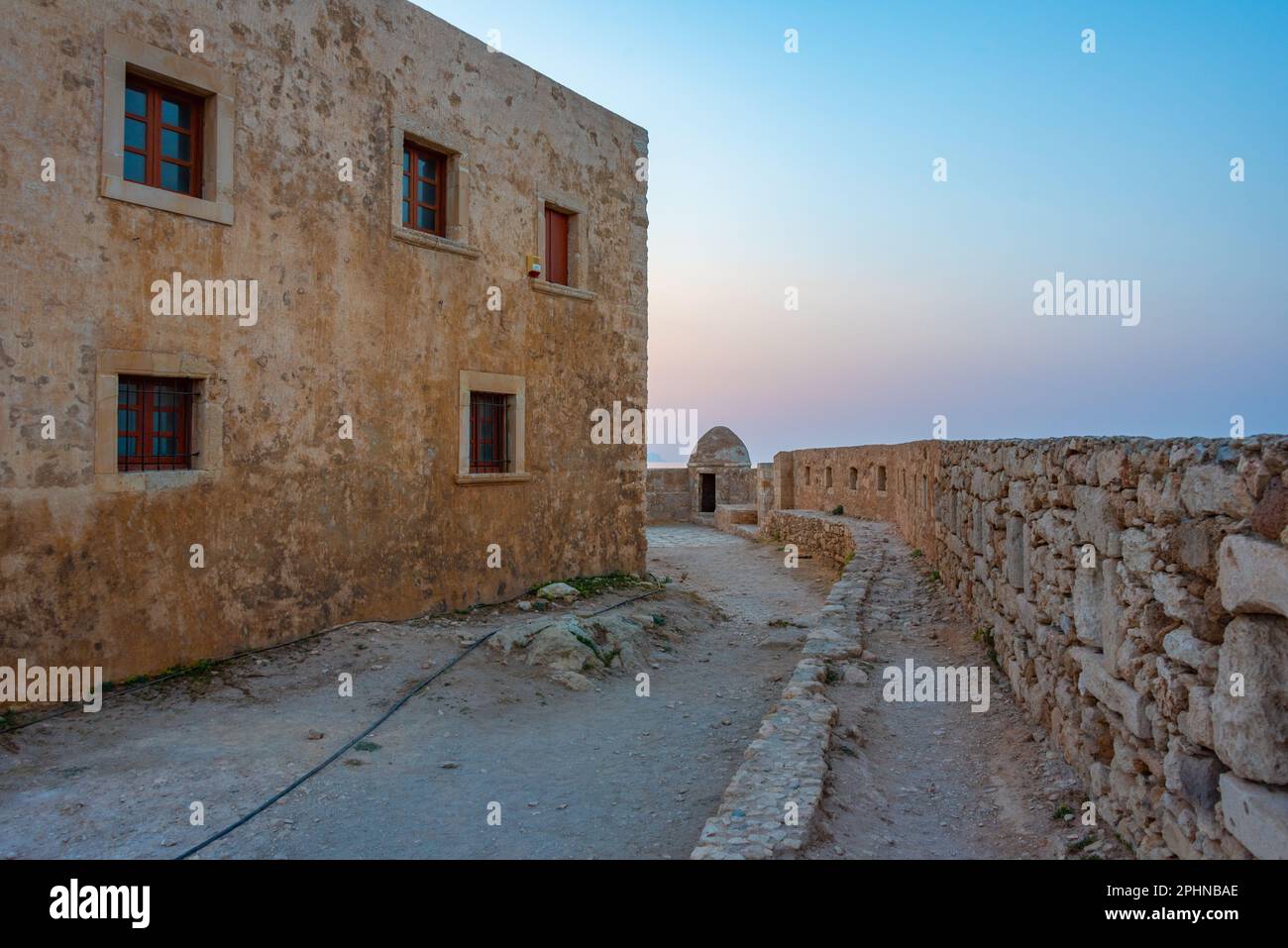 Sunset view of buildings at Venetian Fortezza Castle in Greek town ...