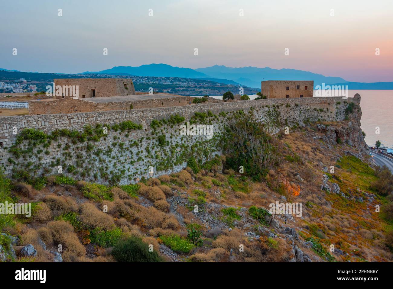 Sunset view of buildings at Venetian Fortezza Castle in Greek town ...
