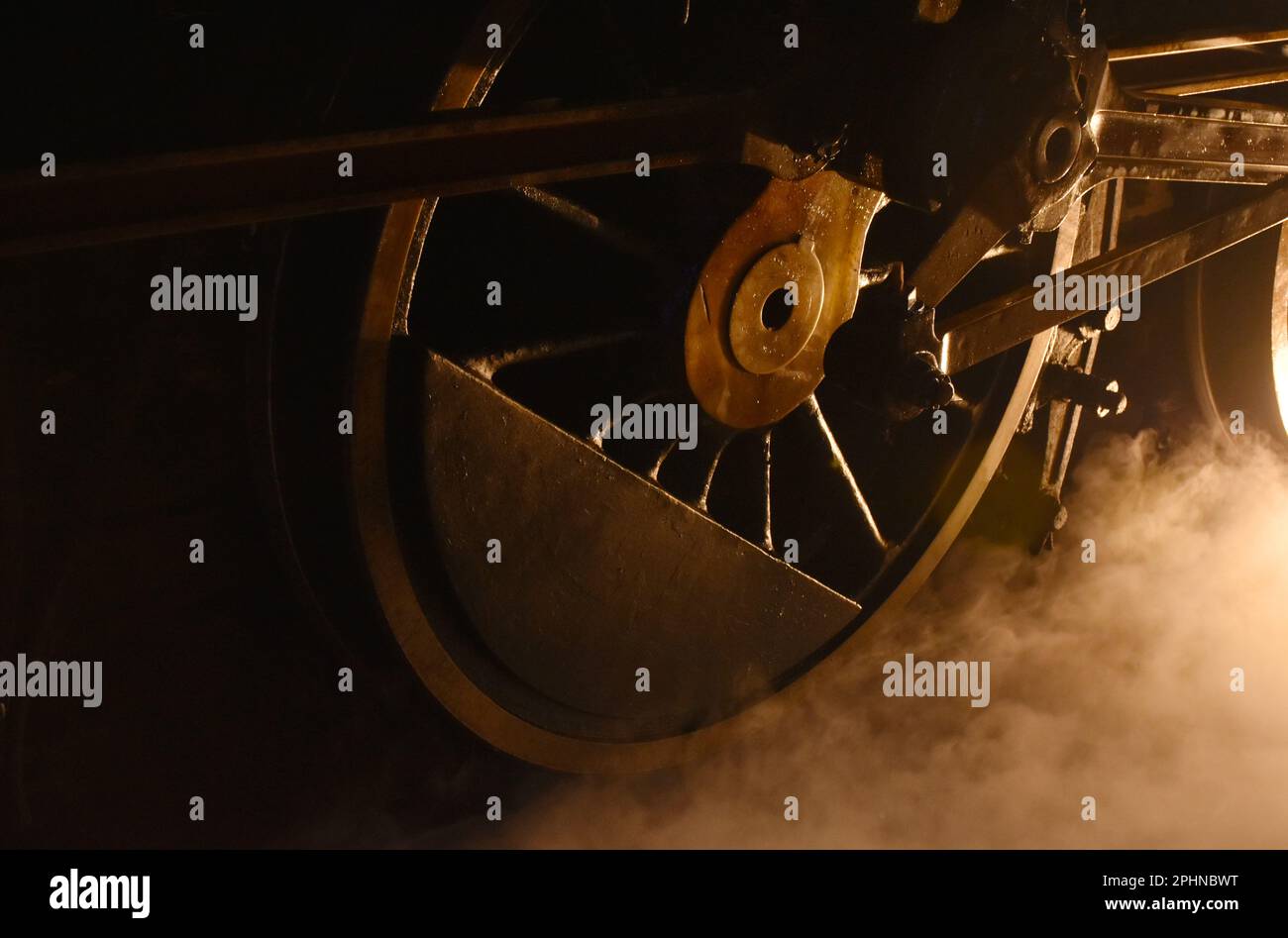 steam locomotive iron wheel with smoke floating on railway in night ...