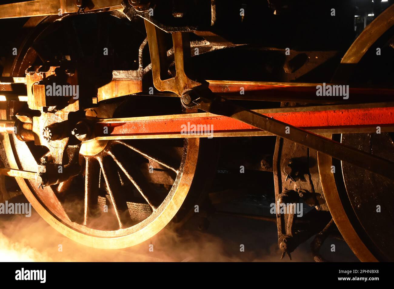 steam locomotive iron wheel with smoke floating on railway in night ...