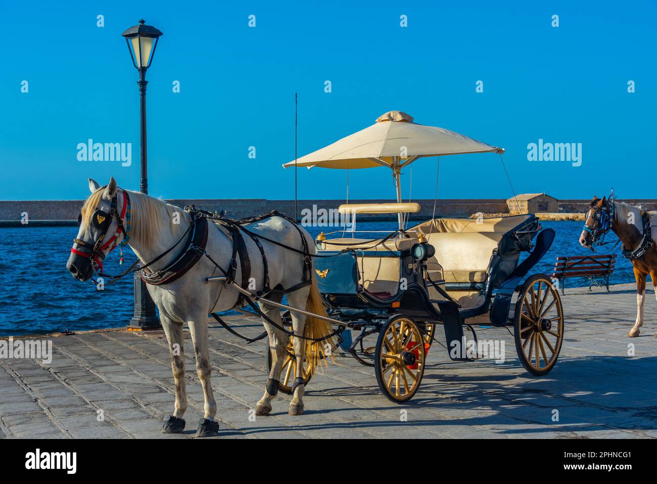 Horse carriage at the Venetian port of Chania in greece Stock Photo - Alamy