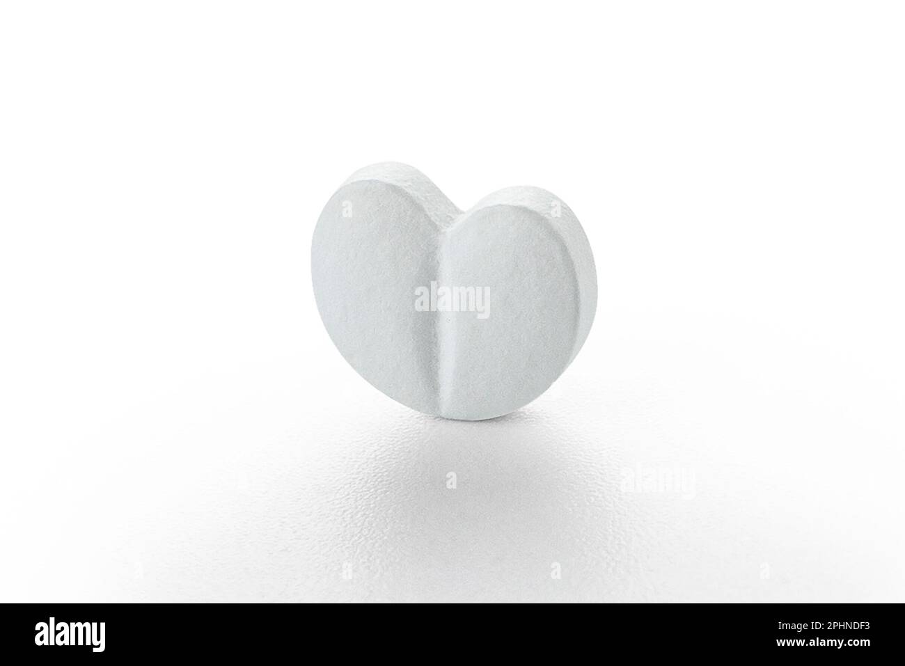 Heart shaped health care pill isolated on a white background. With ...