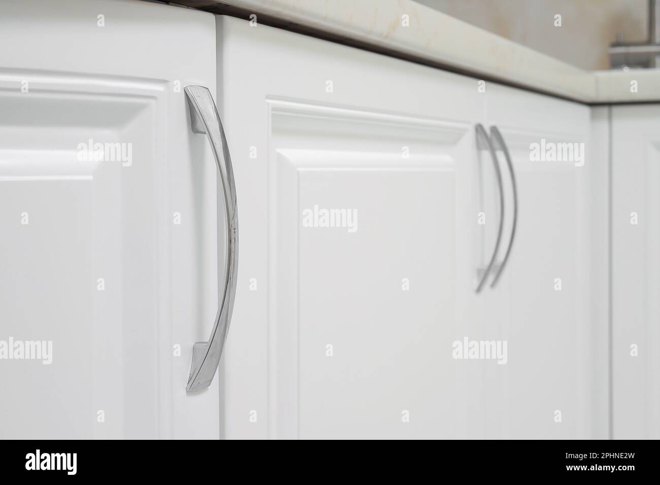 Kitchen furniture chrome door handle Stock Photo - Alamy