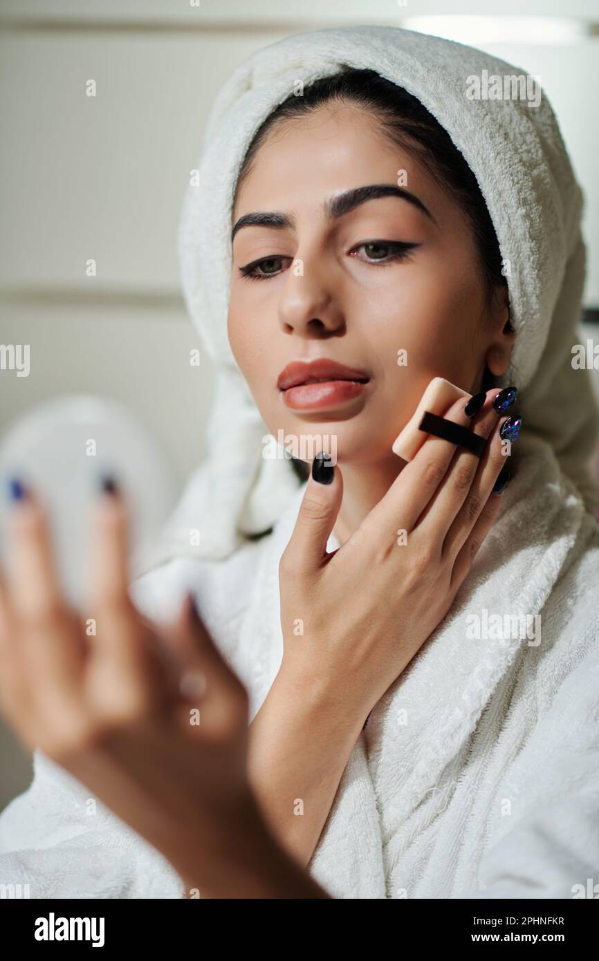 Hand applying foundation on face hi-res stock photography and images ...