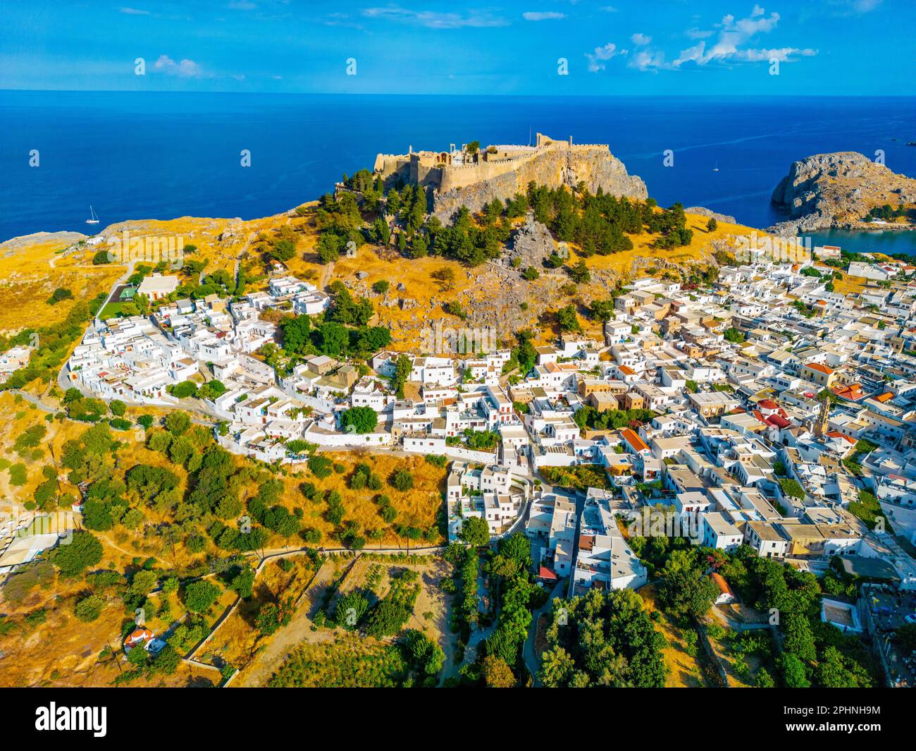 Acropolis of Lindos overlooking traditional white houses at Rhodes ...
