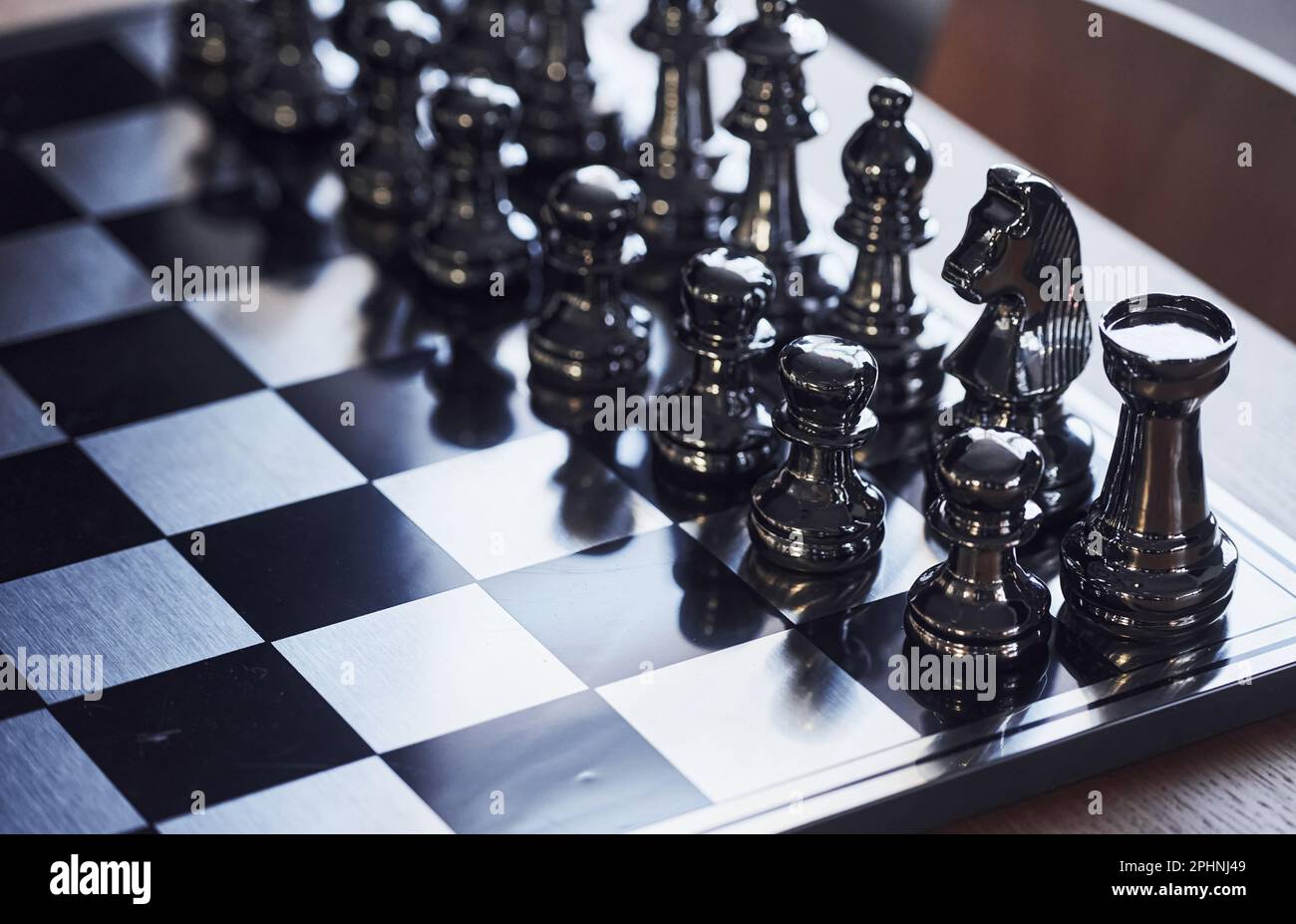 Chess board with metal figures on it indoors on the table at daytime ...