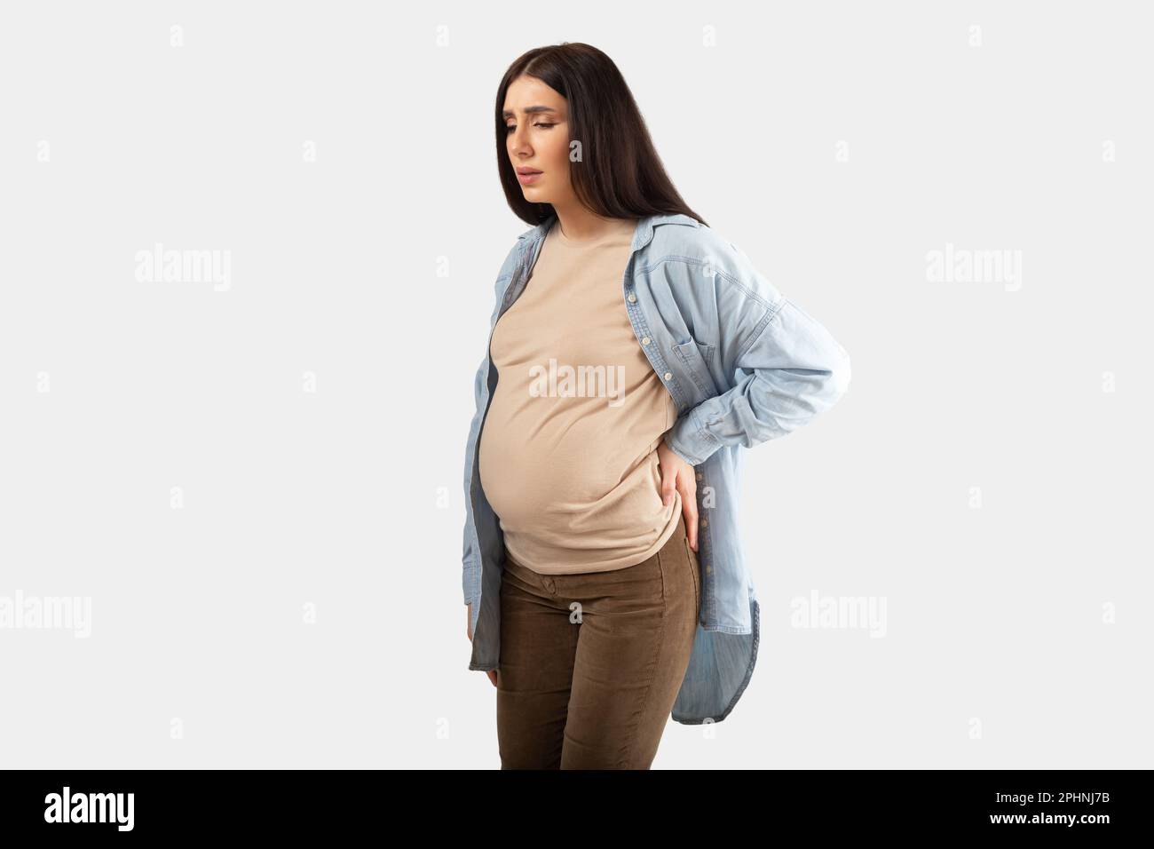 Pregnancy backache. Portrait of pregnant woman suffering lower back ...