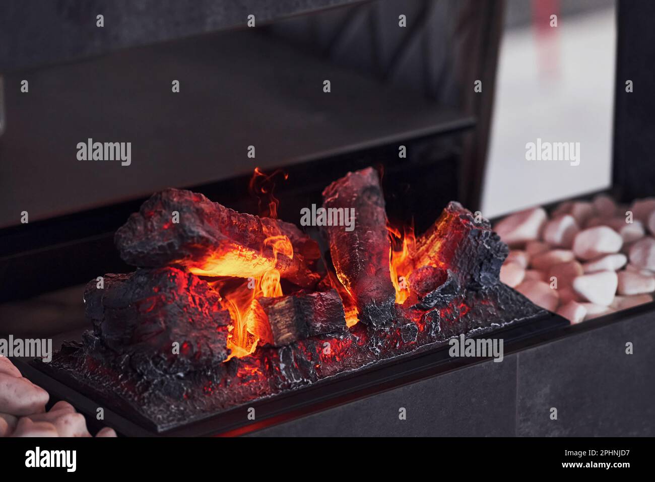 Burned wood on the surface of fireplace indoors at home at daytime ...