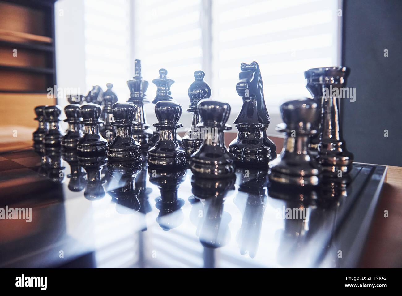 Chess board with metal figures on it indoors on the table at daytime ...