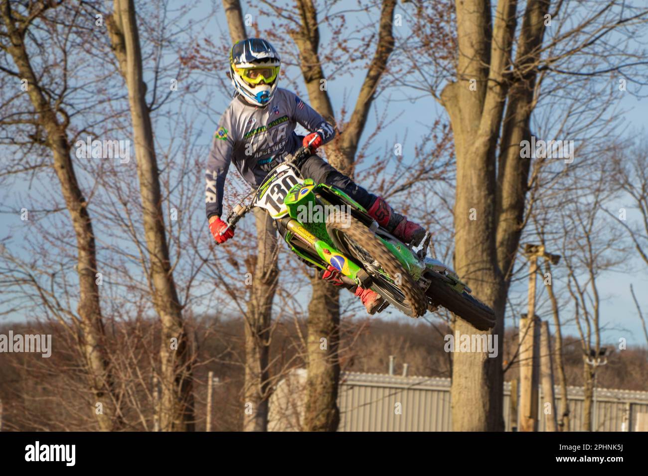 A daring man rides a dirt bike across a dusty terrain Stock Photo - Alamy